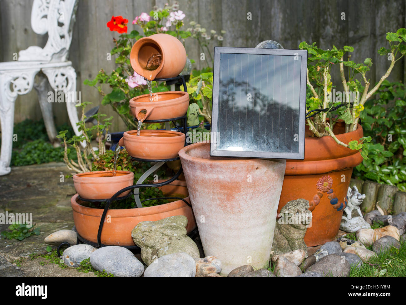 A terracotta water feature using solar power in garden UK Stock Photo ...