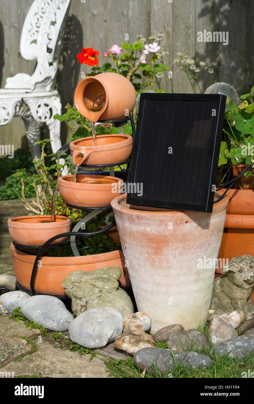 A terracotta water feature using solar power in garden UK Stock Photo ...