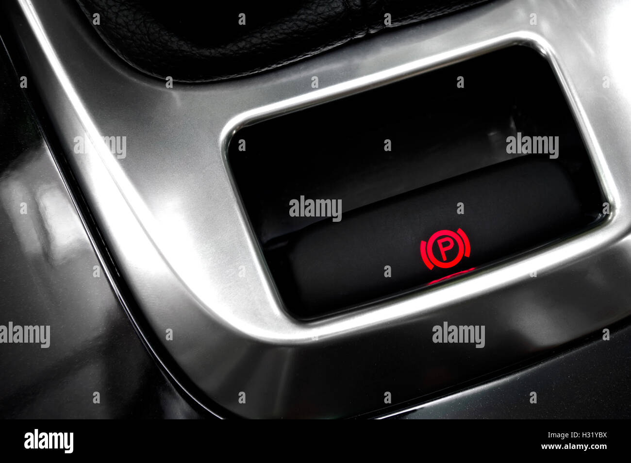 Close-up to a hand brake button in a car Stock Photo - Alamy