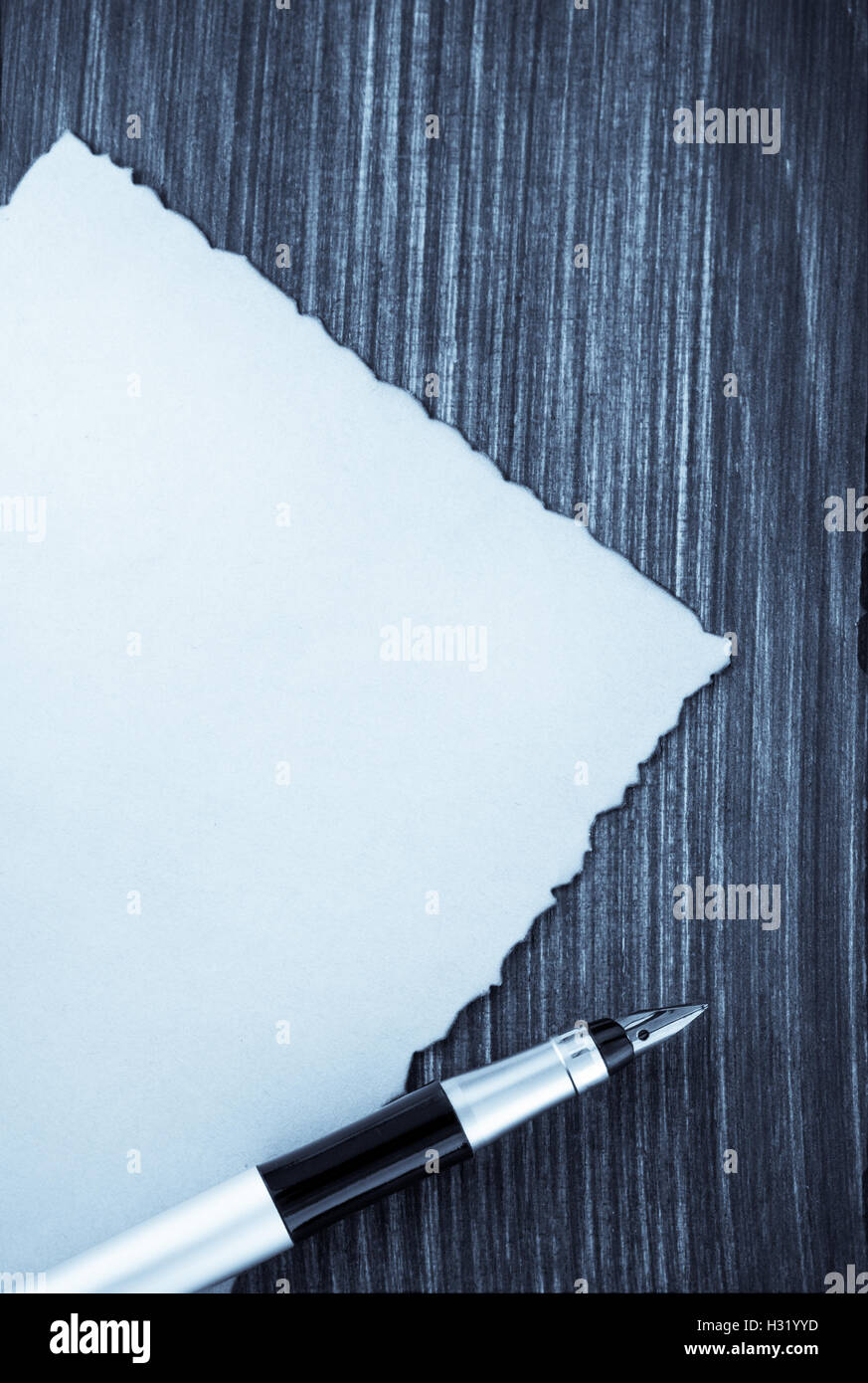 paper parchment and ink pen on wooden background Stock Photo - Alamy