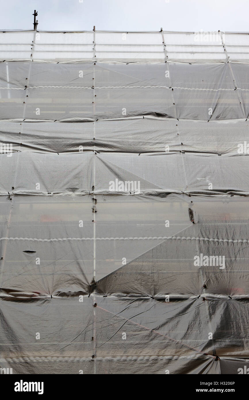 Building covered in scaffolding & plastic sheets Stock Photo - Alamy