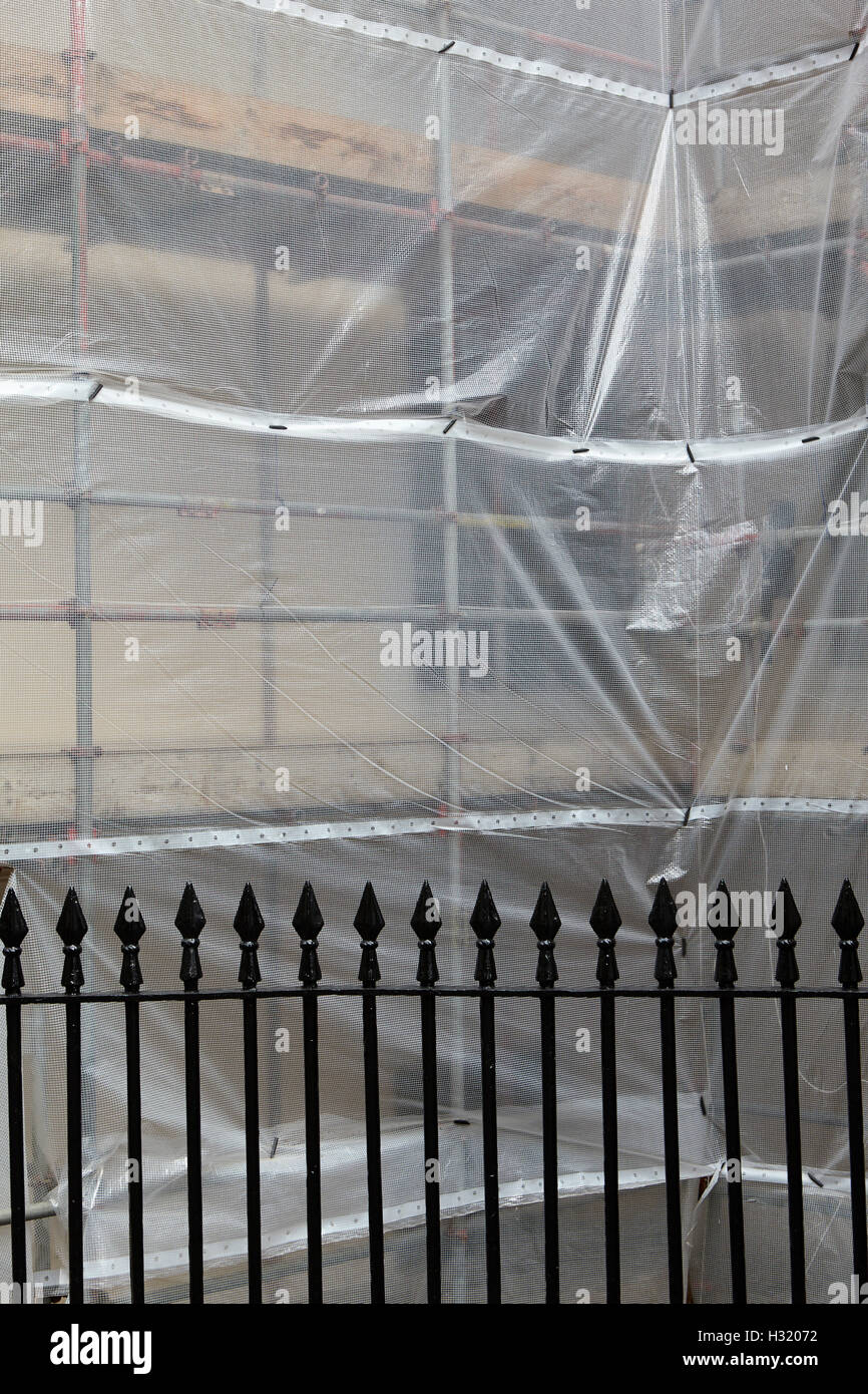 Building covered in scaffolding & plastic sheets Stock Photo - Alamy