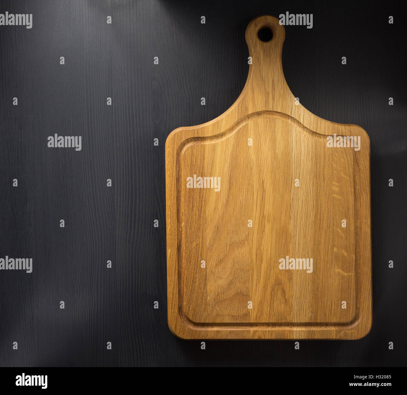 cutting board at wooden table surface Stock Photo - Alamy