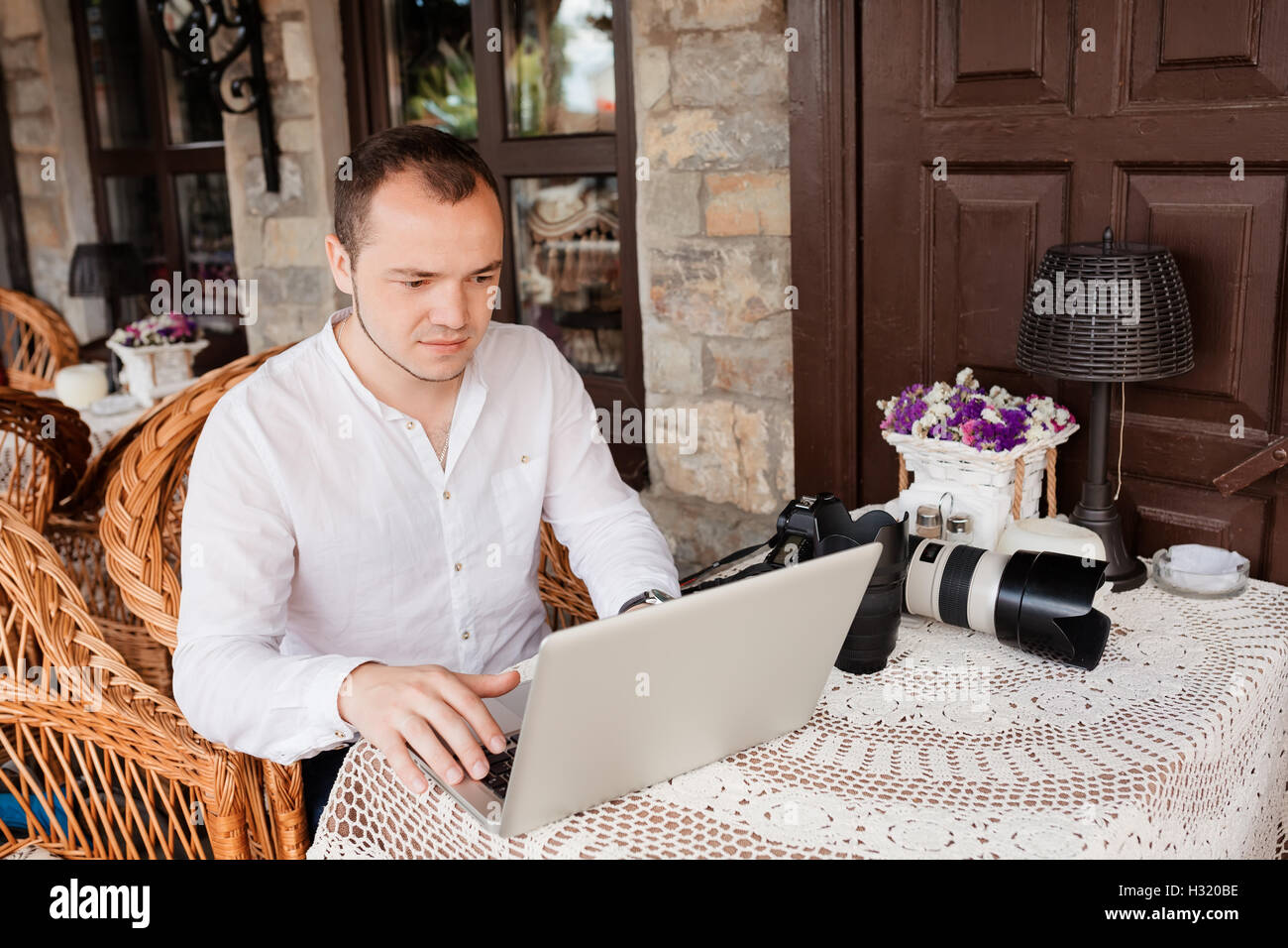 Young man internet browsing at the cafe bar Stock Photo - Alamy