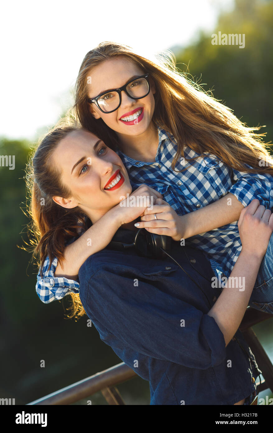 Two playful young women having fun outdoors at sunset light Stock Photo ...