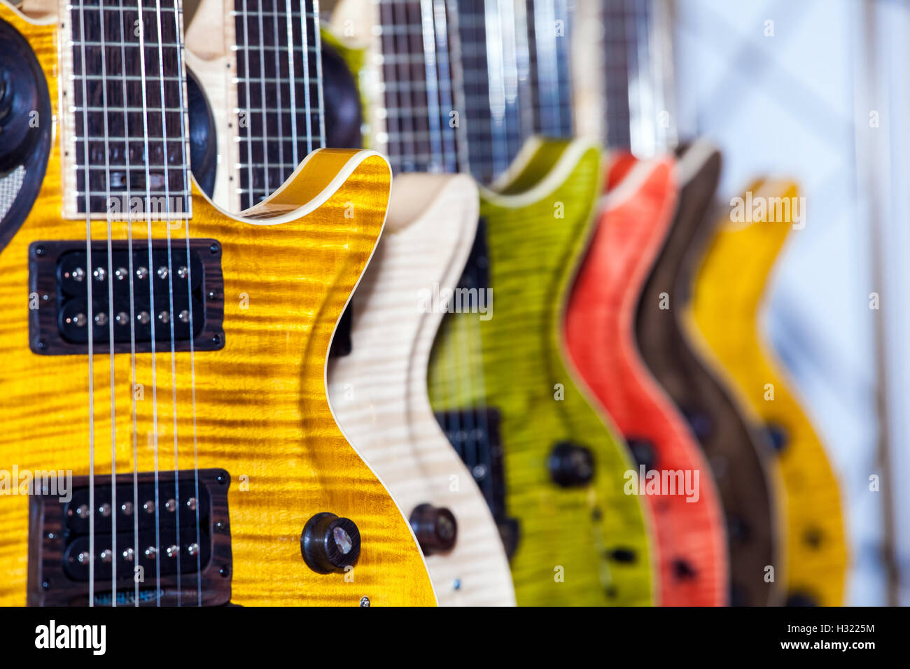 Many colorful guitars in musical shop Stock Photo - Alamy