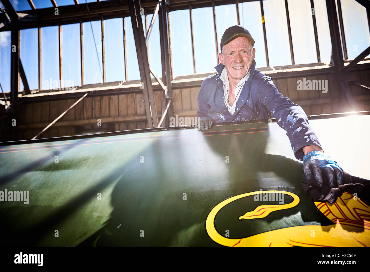 A man polishes the side of a steam engine at Didcot Railway Centre as ...