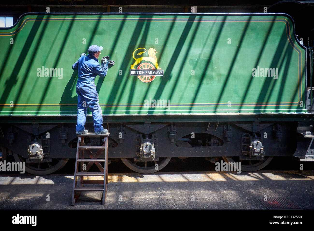 A man polishes the side of a steam engine at Didcot Railway Centre as ...