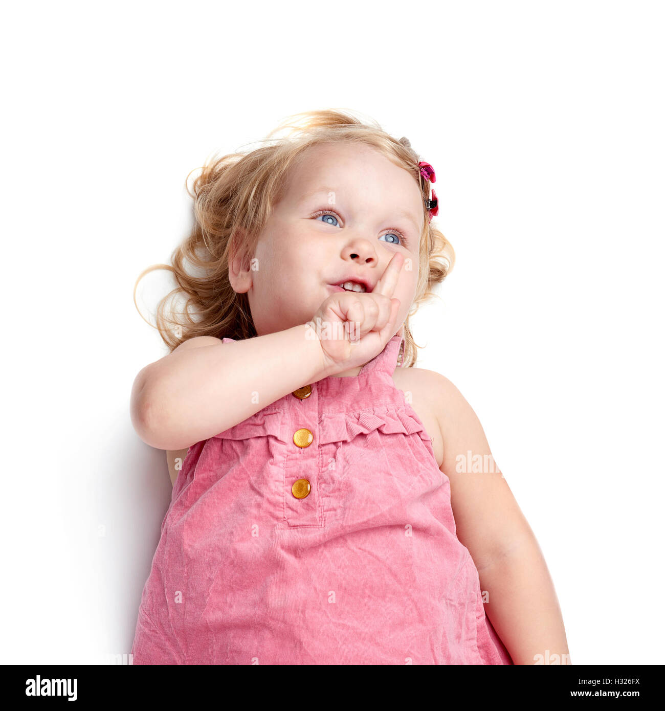 Young little girl lying over isolated white background Stock Photo - Alamy