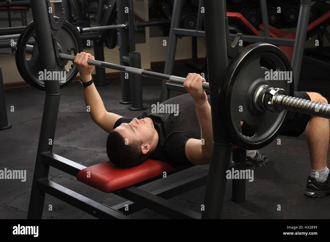 young man doing bench press workout in gym Stock Photo - Alamy