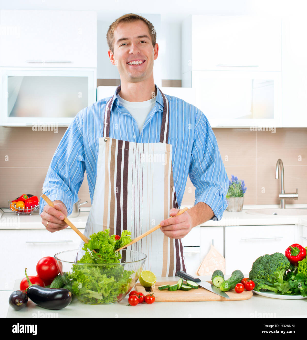 Young Man Cooking. Healthy Food - Vegetable Salad Stock Photo - Alamy