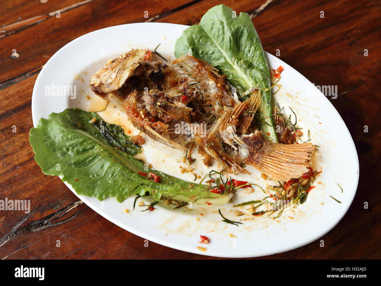 eaten Fried ruby fish topped with sweet,sauer and hot sauce Stock Photo ...