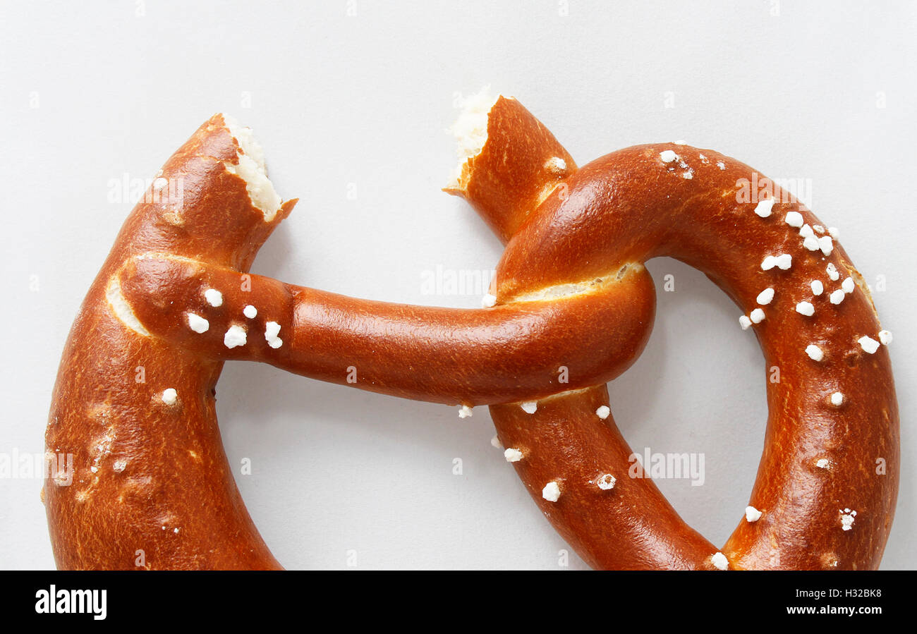 Pretzel or brezel bread, missing bite Stock Photo - Alamy