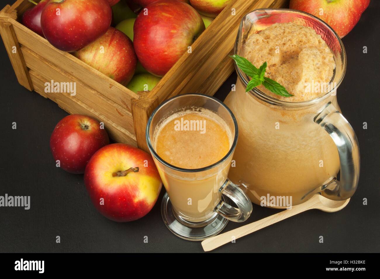 Fresh pressed apple juice unfiltered. Apple juice and apples on wooden ...
