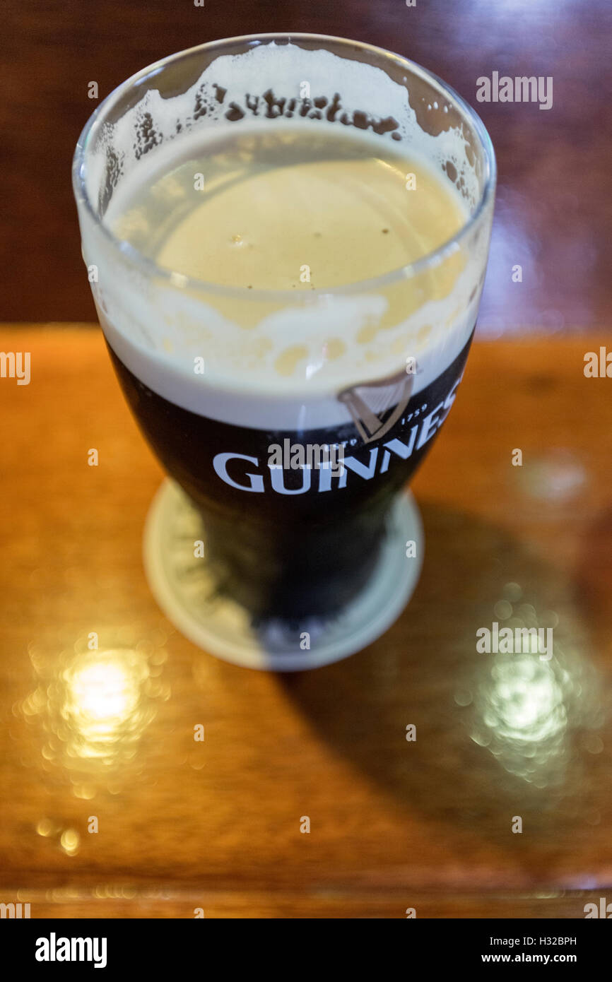 Nearly full empty Guinness pint, in Donegal, Ireland Stock Photo - Alamy