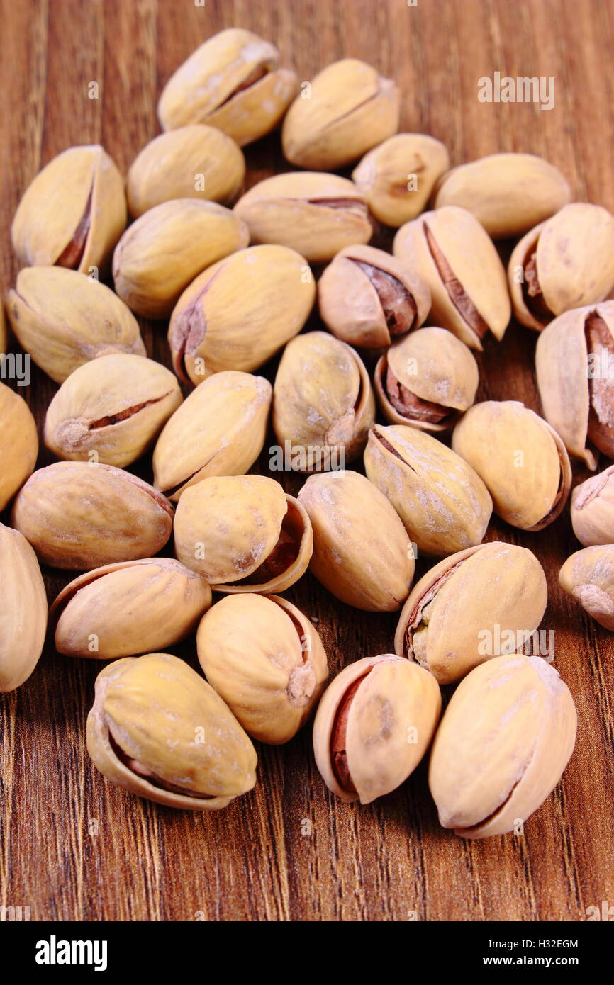 Roasted pistachio nuts on wooden board, healthy food and nutrition Stock Photo - Alamy