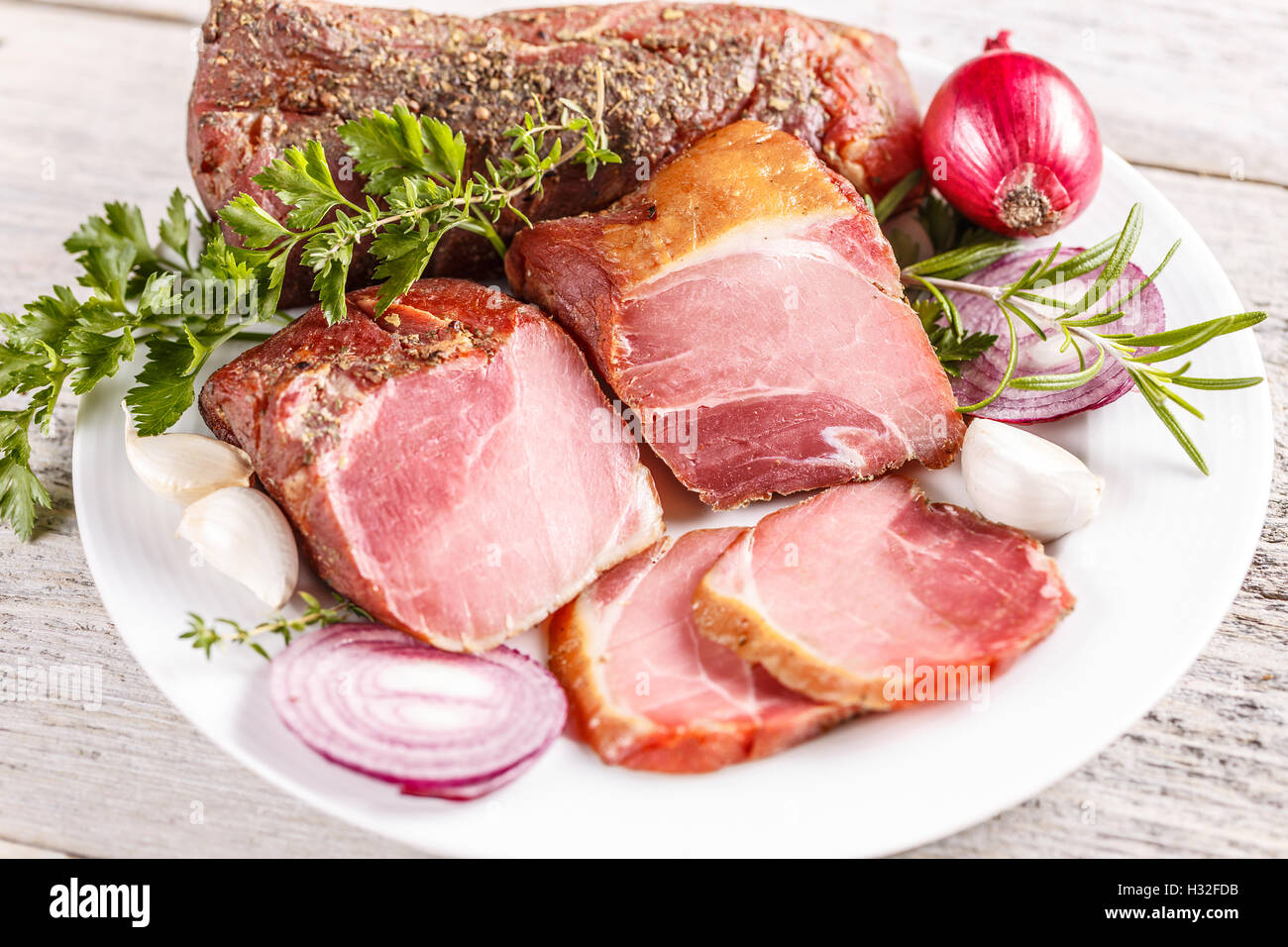 Smoked meats on white plate Stock Photo - Alamy