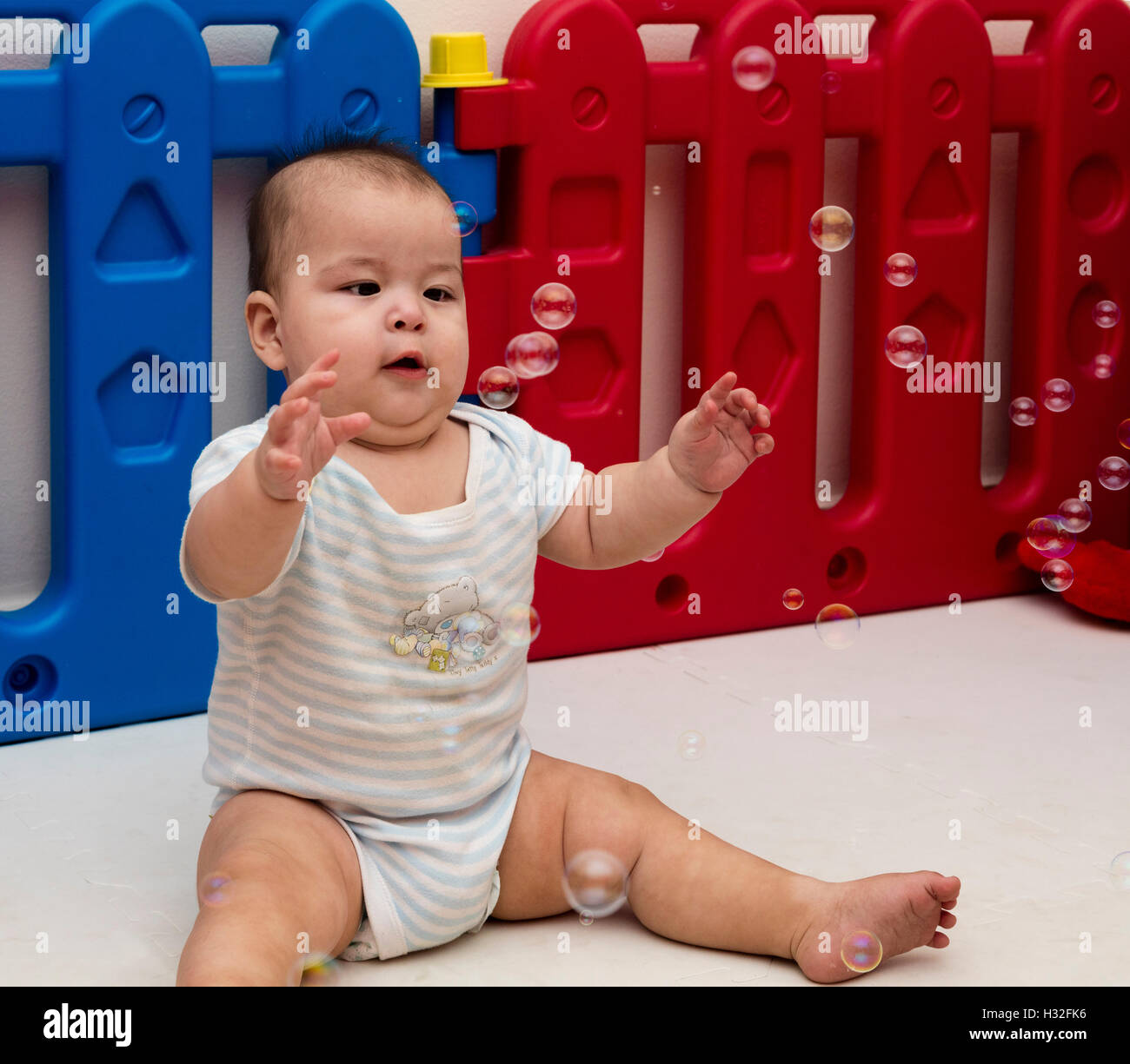 baby trying to catch bubbles Stock Photo - Alamy