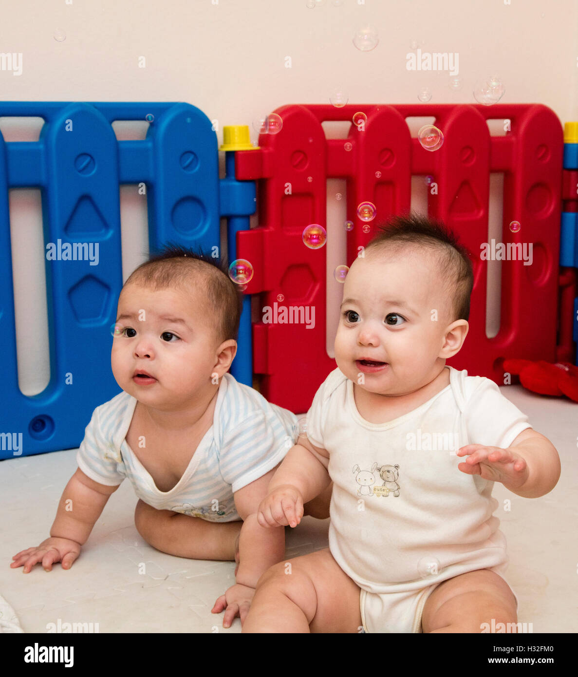 twin babies enjoying bubbles Stock Photo - Alamy