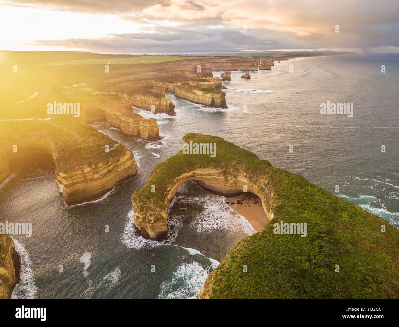 Aerial view of Mutton Bird Island arches at sunrise. Great Ocean Road ...