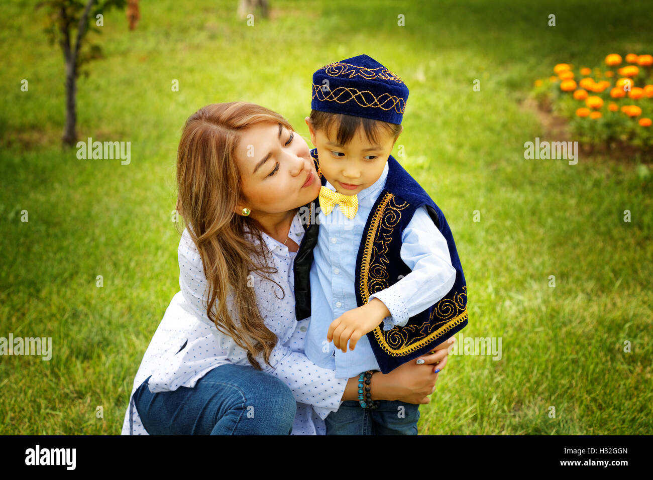 Kazakh mother with children. Son and daughter in the summer park Stock ...