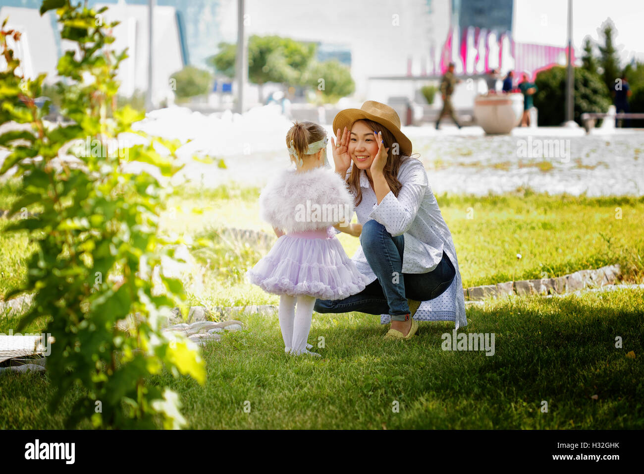 Kazakh mother with children. Son and daughter in the summer park Stock ...