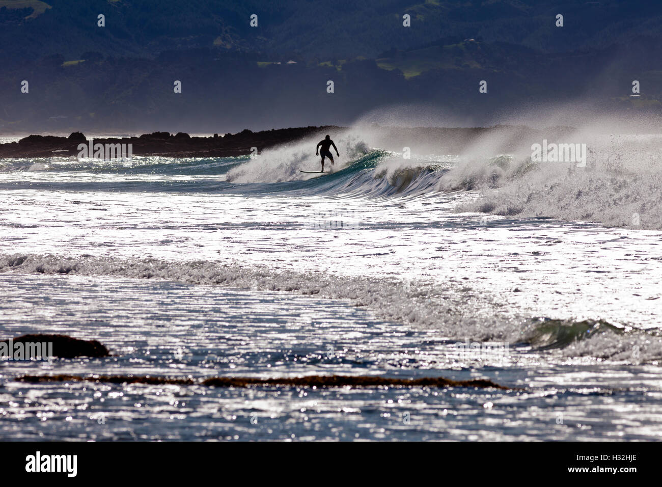 Surfboard surfer surfing big wave ocean surf Stock Photo - Alamy