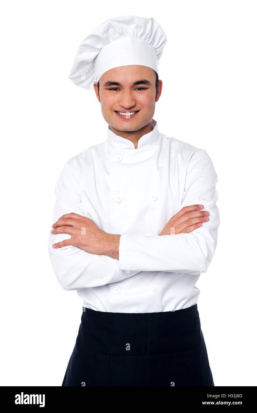 Confident young cook posing in uniform Stock Photo - Alamy