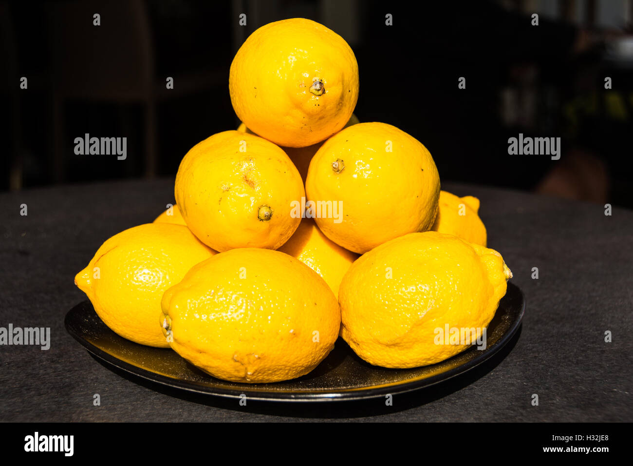 A dish of bright yellow lemons in the morning sun Stock Photo - Alamy