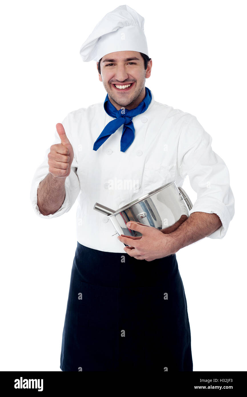 Chef holding a pot showing the ok hand sign Stock Photo - Alamy