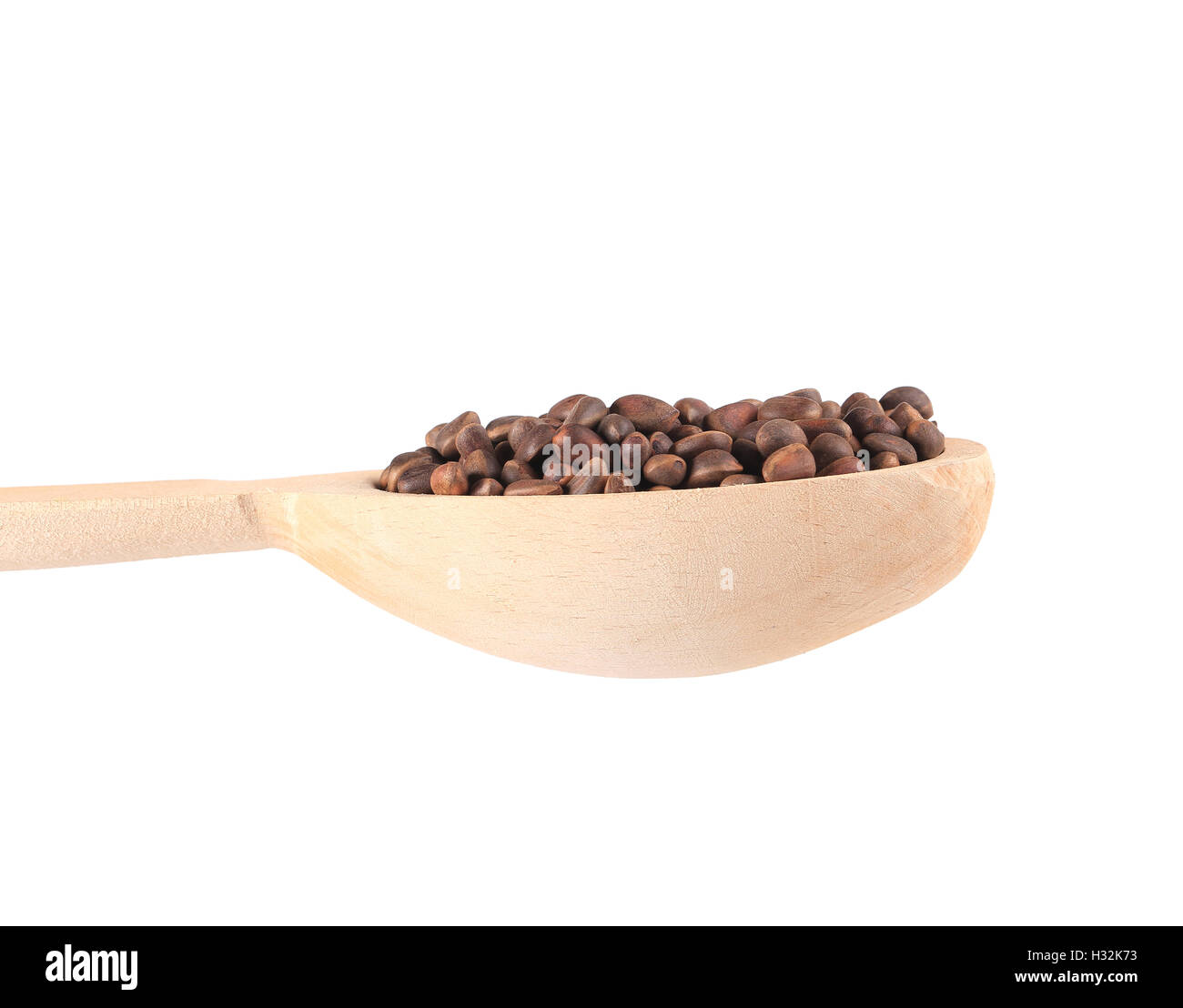 Wooden spoon full with pine nuts Stock Photo - Alamy
