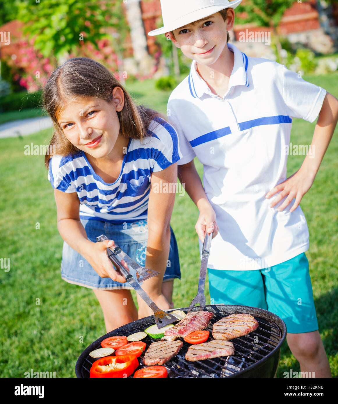 Kids having a barbecue party Stock Photo - Alamy