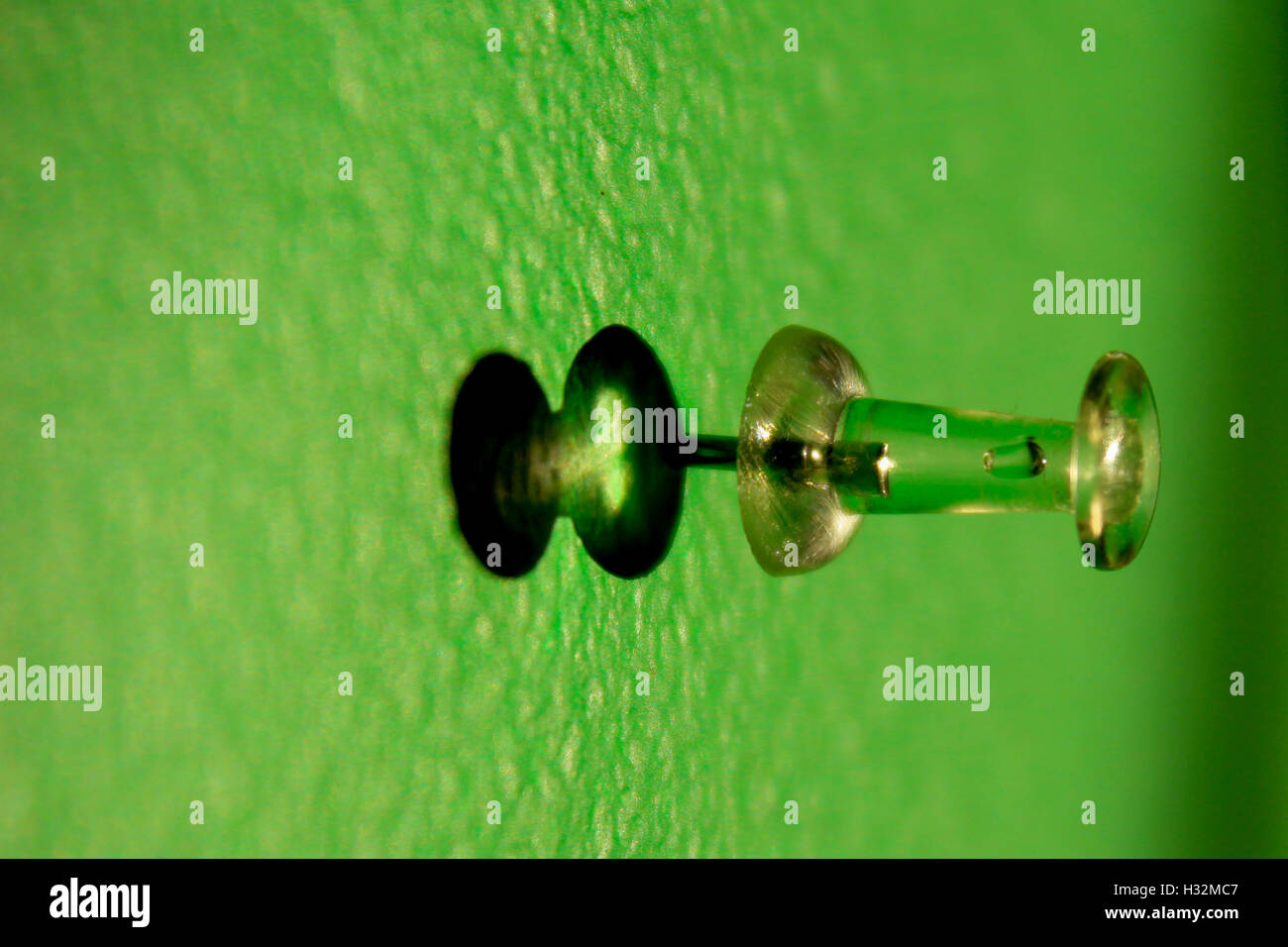 Thumbtack Pinned to wall Stock Photo - Alamy