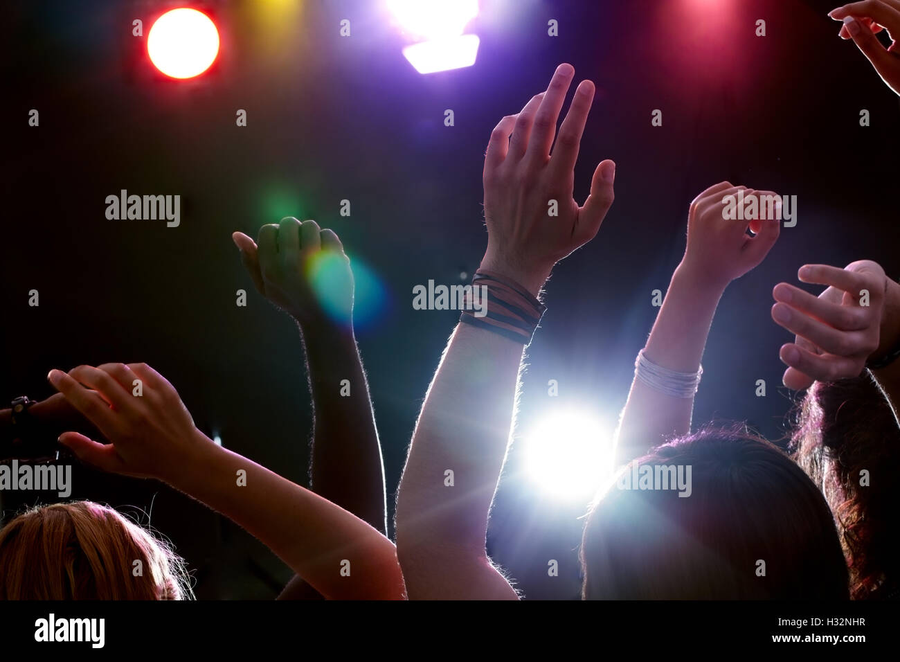 Crowd with raised up hands dancing in nightclub hi-res stock ...