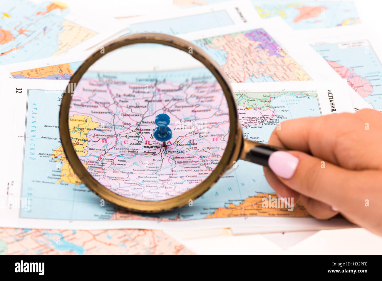 magnifying glass on a map - close-up Stock Photo - Alamy
