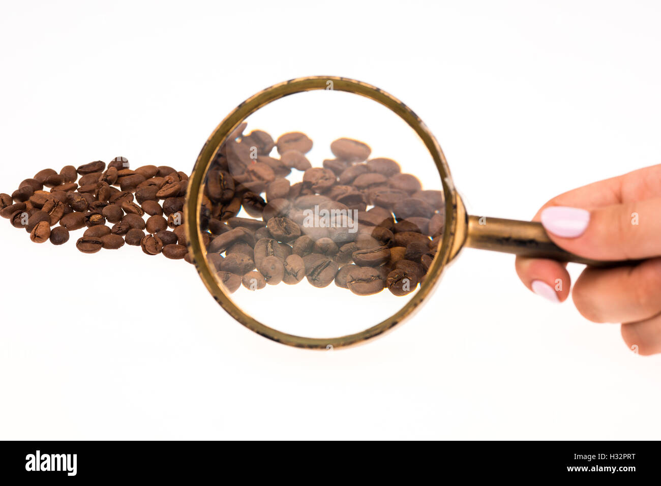 Female hand keepig magnifying glass over the coffee beans Stock Photo ...