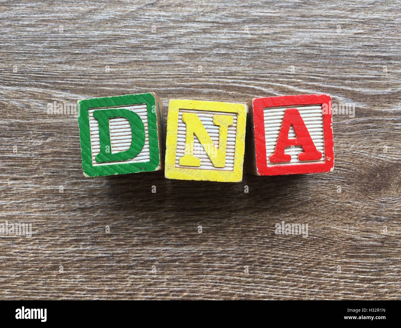 Alphabet wood block letters forming the acronym DNA, combining those ...