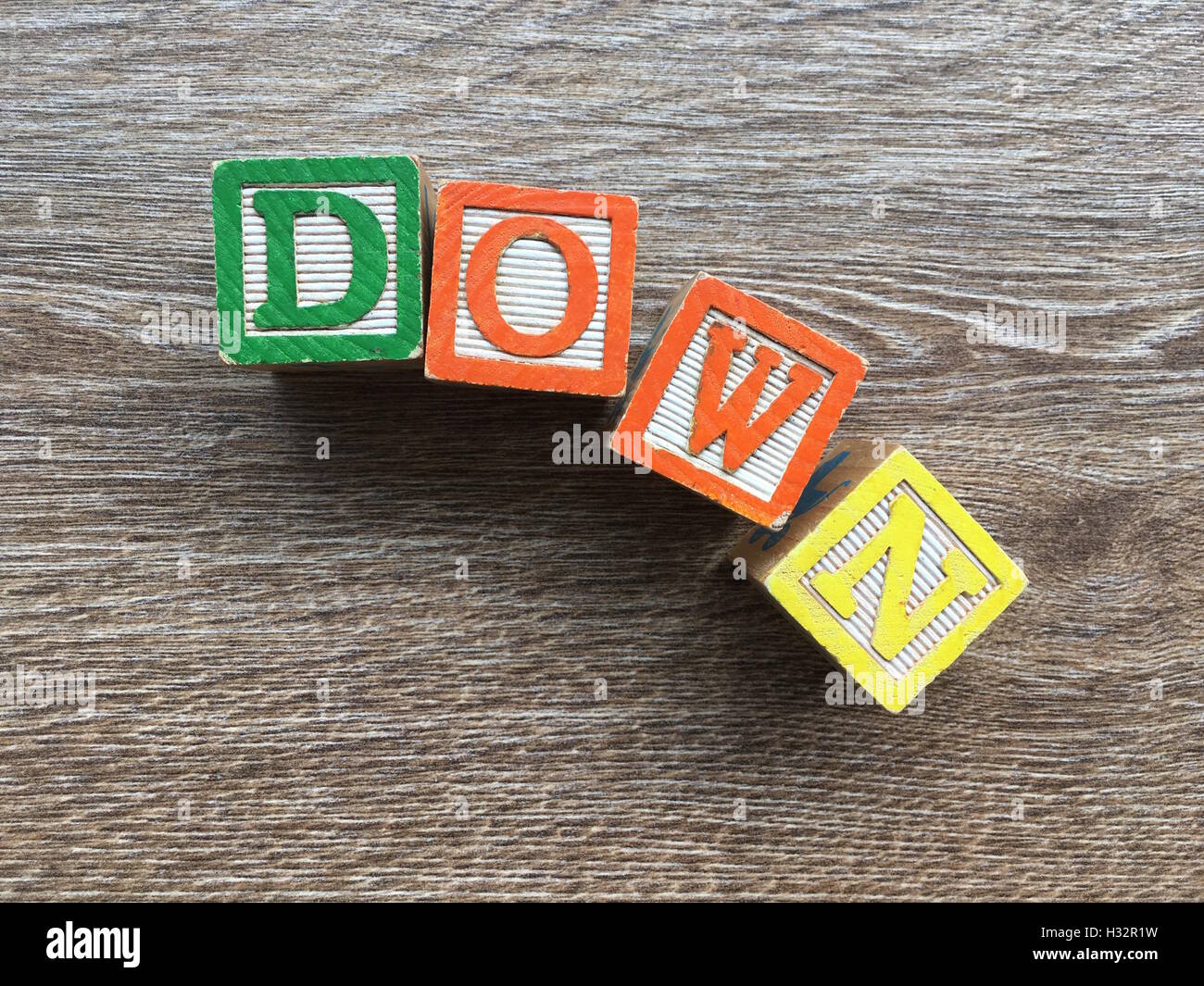 Alphabet wood block letters forming the word DOWN , it is a way for ...