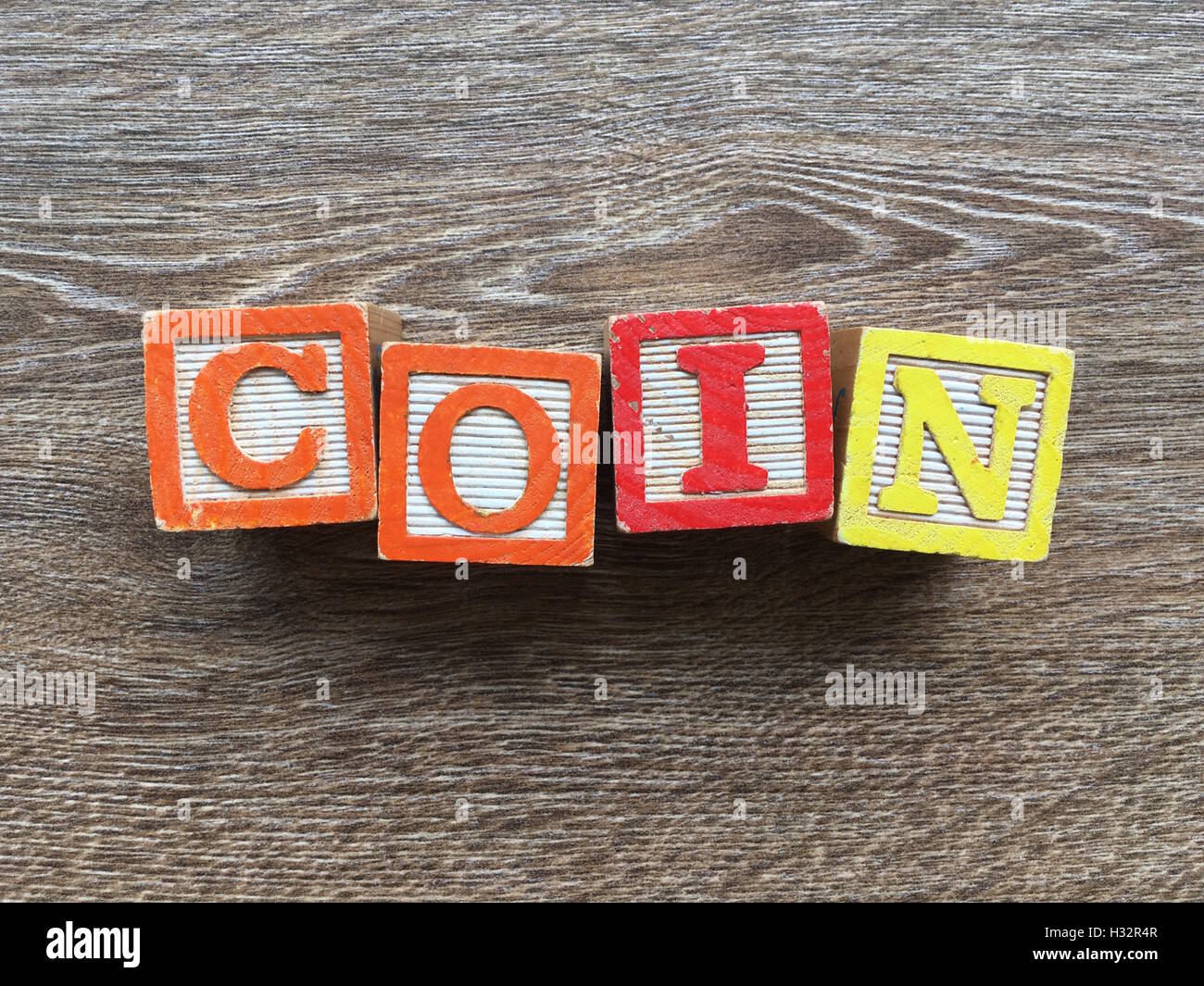 Alphabet wood block letters forming the word COIN, it is a way for ...