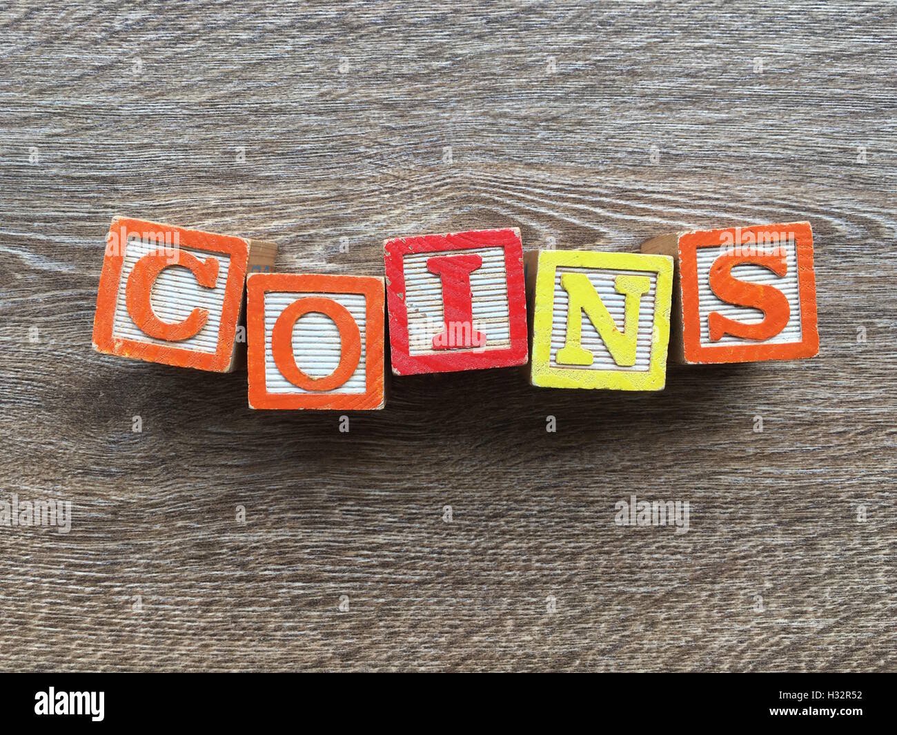 Alphabet wood block letters forming the word COINS, it is a way for ...