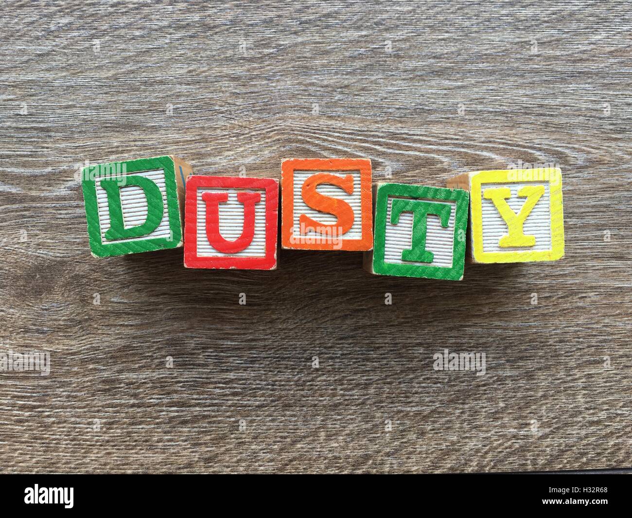 Alphabet wood block letters forming the word DUSTY, it is a way for ...