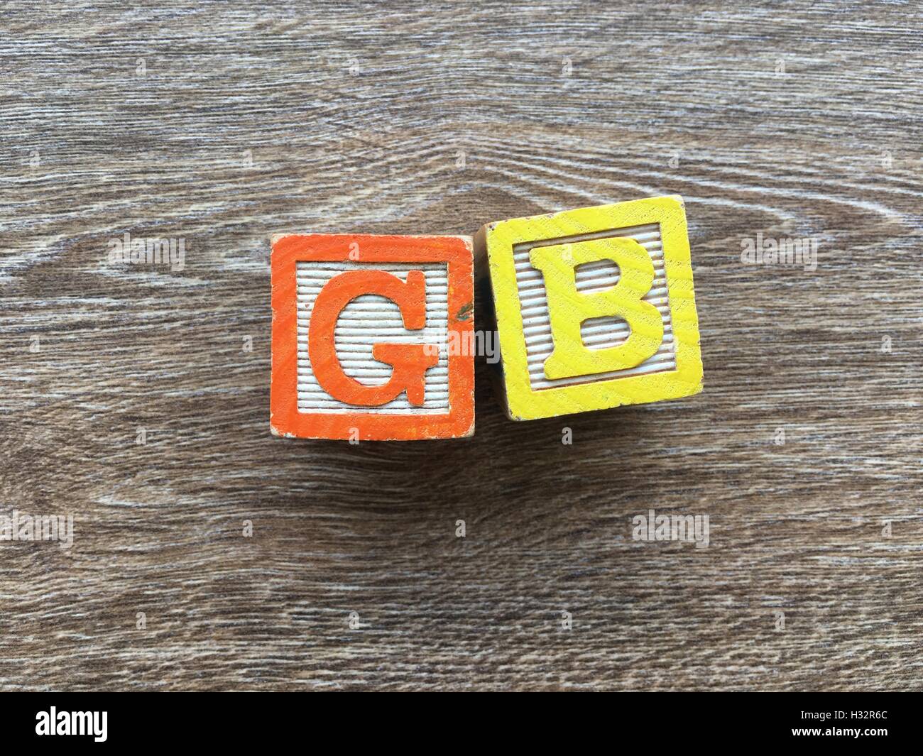 Alphabet wood block letters forming the abbreviation GB for Great ...