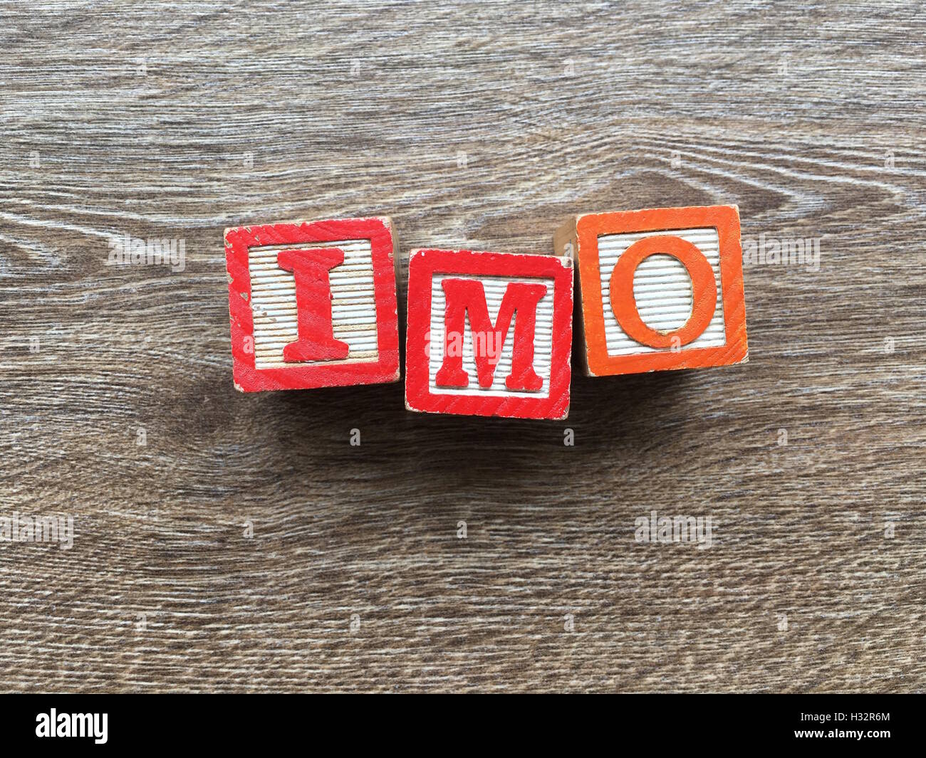 Alphabet wood block letters forming the acronym IMO for In My Opinion ...