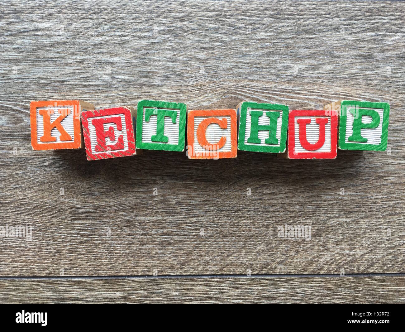 Alphabet wood block letters forming the word KETCHUP. It's a typography ...