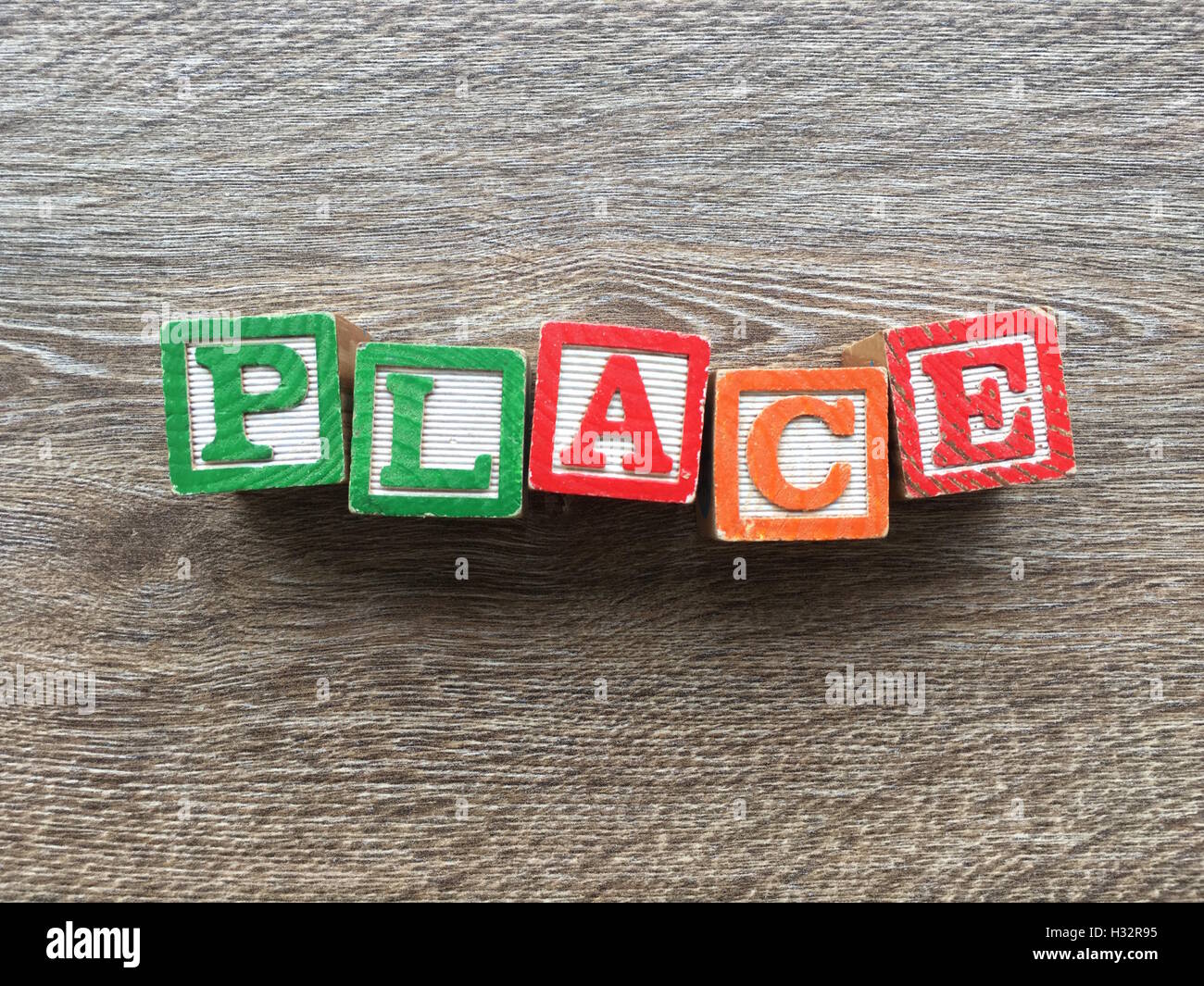 Alphabet wood block letters forming the word PLACE. It's a typography ...