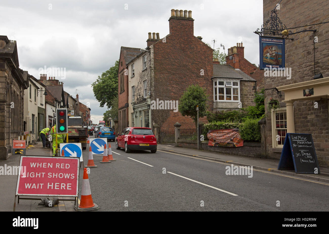 Roadworks in narrow street lined with historic brick buildings in ...