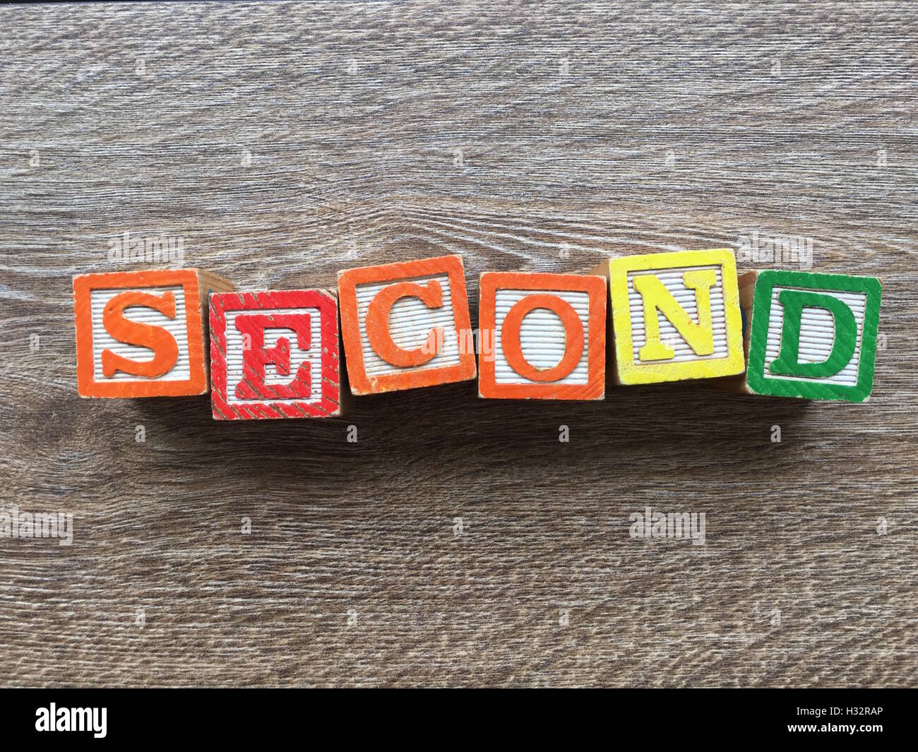 Alphabet wood block letters forming the word SECOND. It's a typography ...