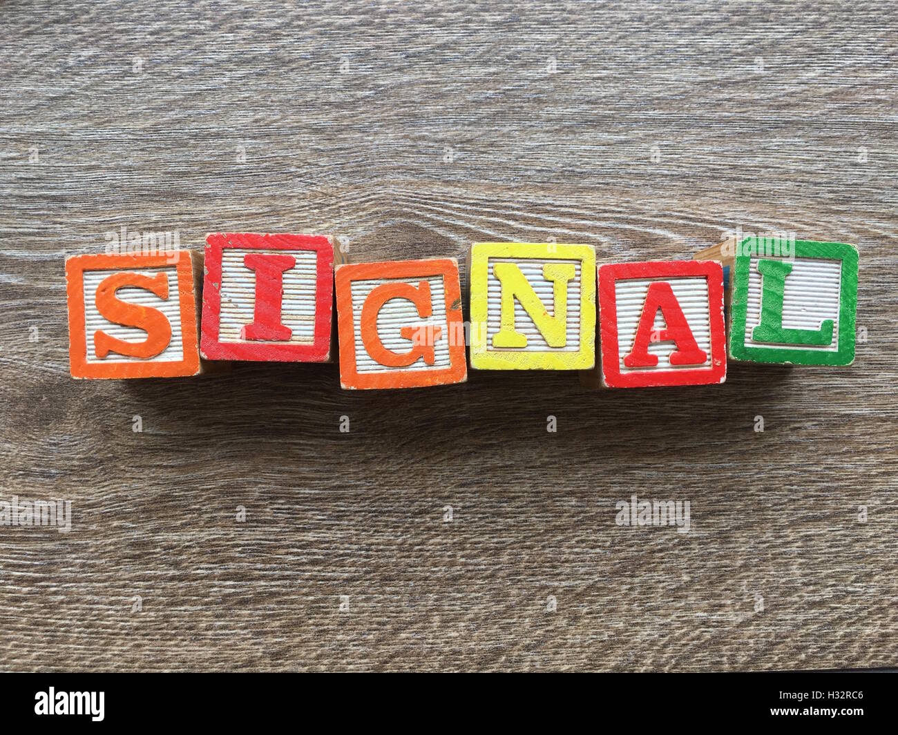 Alphabet wood block letters forming the word SIGNAL. It's a typography ...