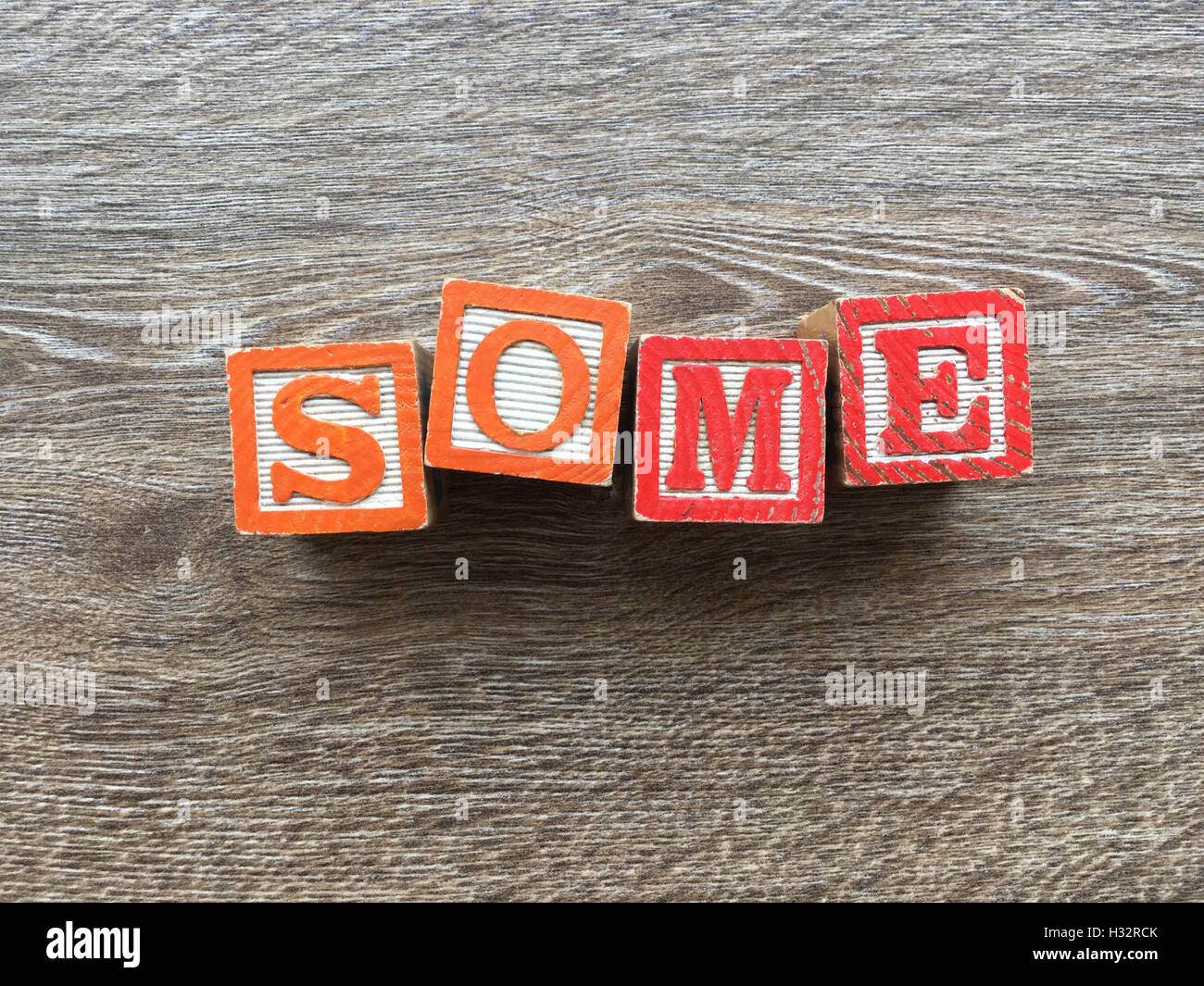 Alphabet wood block letters forming the word SOME. It's a typography ...