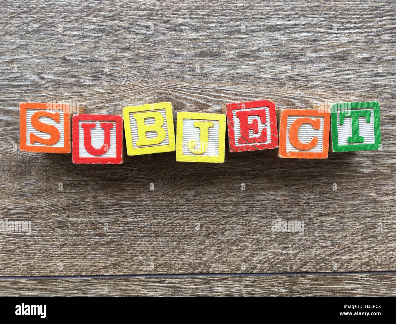 Alphabet wood block letters forming the word SUBJECT. It's a typography ...